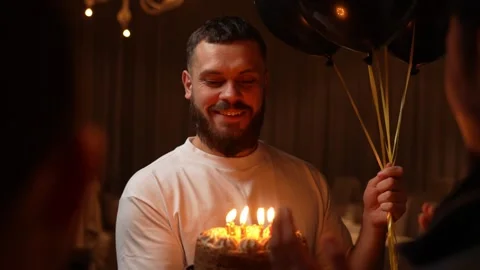 Young man making a wish and blowing cand... | Stock Video | Pond5