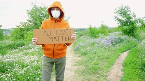 Young man in a mask with a cardboard pos... | Stock Video | Pond5