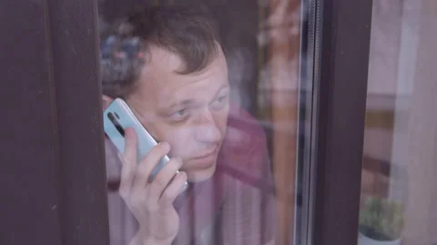 Young man outside the window, looking at... | Stock Video | Pond5