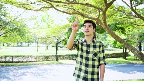 Young man pressing button in park. | Stock Video | Pond5