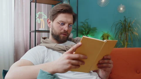Young man relaxing interesting book turn... | Stock Video | Pond5