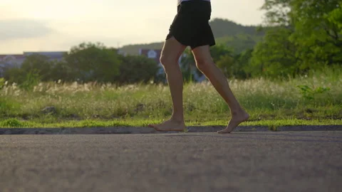A young man running barefoot. Barefoot r... | Stock Video | Pond5