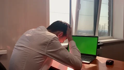 A young man sitting at a computer with a... | Stock Video | Pond5