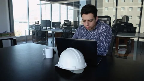Young man sitting at desk at work next t... | Stock Video | Pond5