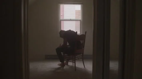 Young Man Sitting Hunched Over On Chair ... | Stock Video | Pond5