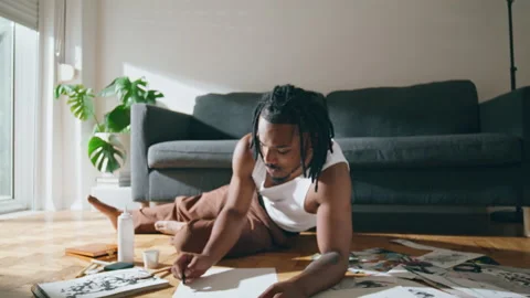 Young man sketching paper at flat zoom o... | Stock Video | Pond5