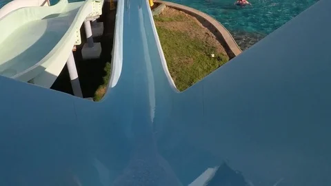 A young man sliding down at water slide ... | Stock Video | Pond5