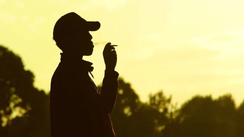 Young man smoking cigarette in front of ... | Stock Video | Pond5