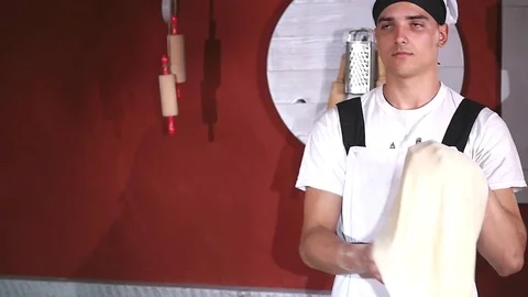 young man spinning and throwing dough up... | Stock Video | Pond5