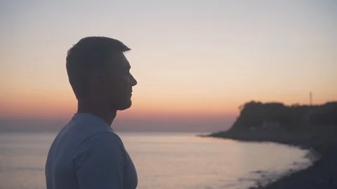 A young man stands on a background of se... | Stock Video | Pond5