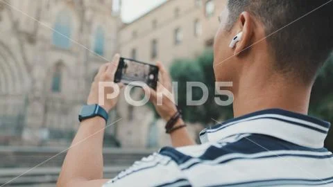 Young man tourist taking photo of sights. Back view Stock Image #229534466