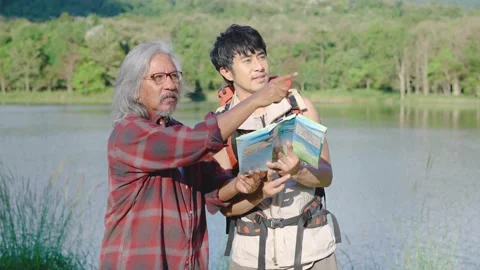 Young man trying to find way using map w... | Stock Video | Pond5