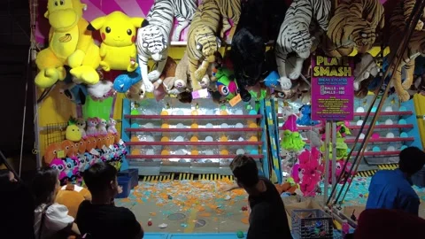 Young Man Trying To Win Prizes Throwing ... | Stock Video | Pond5