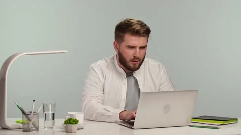 Young man is typing on the computer, bro... | Stock Video | Pond5
