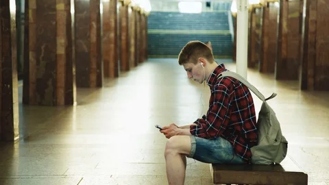 Young man using smartphone waiting for s... | Stock Video | Pond5