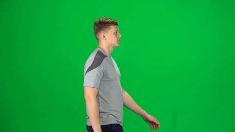 Young man walking on a Green Screen, sid... | Stock Video | Pond5