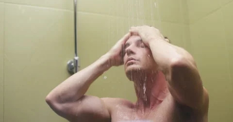 Young man washes out shampoo from black ... | Stock Video | Pond5