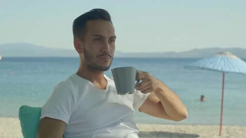 Young man watching the view by the sea w... | Stock Video | Pond5