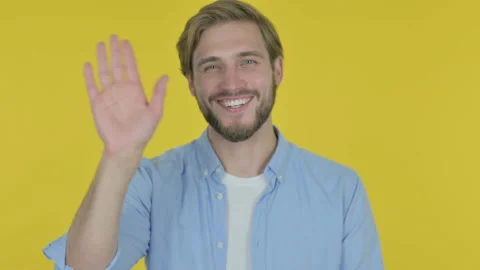 Young Man Waving Hand to Say Hello on Ye... | Stock Video | Pond5