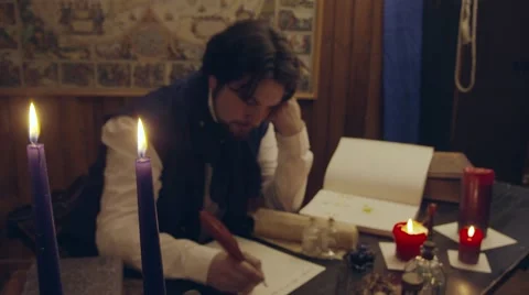 Young man writing letter in mystical off... | Stock Video | Pond5