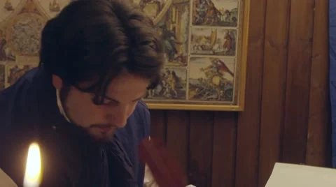Young man writing letter in mystical off... | Stock Video | Pond5
