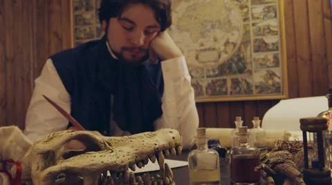 Young man writing letter in mystical off... | Stock Video | Pond5