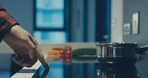 Young man's hand turning on induction hu... | Stock Video | Pond5