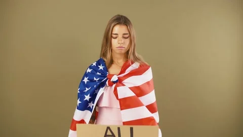 Young model wrapped in flag of USA. She ... | Stock Video | Pond5