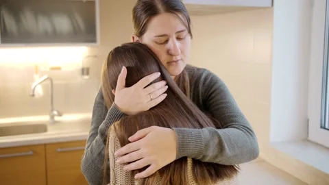 Young mother hugging and consoling upset... | Stock Video | Pond5
