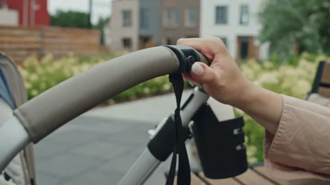 Young Mother Pushing And Pulling Baby St... | Stock Video | Pond5