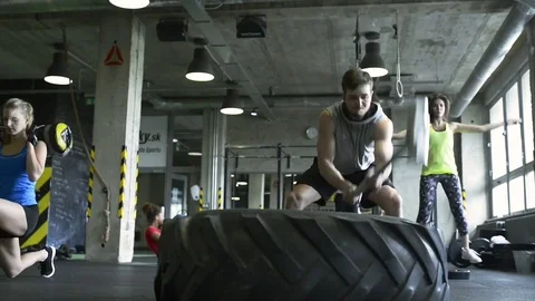 Young people in crossfit gym working out... | Stock Video | Pond5