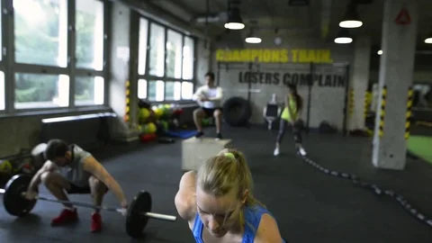 Young people in crossfit gym working out... | Stock Video | Pond5