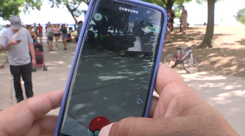 Young people playing Pokemon go game on ... | Stock Video | Pond5