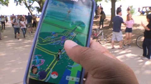 Young people playing Pokemon go game on ... | Stock Video | Pond5