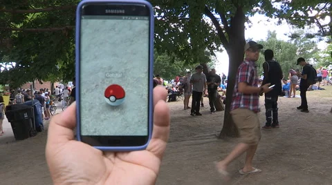 Young people playing Pokemon go game on ... | Stock Video | Pond5