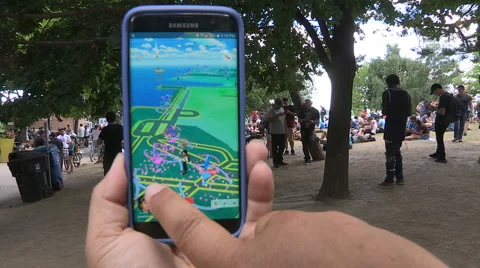 Young people playing Pokemon go game on ... | Stock Video | Pond5
