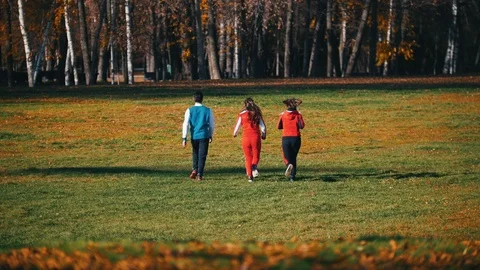 Young people running in the park. Back v... | Stock Video | Pond5