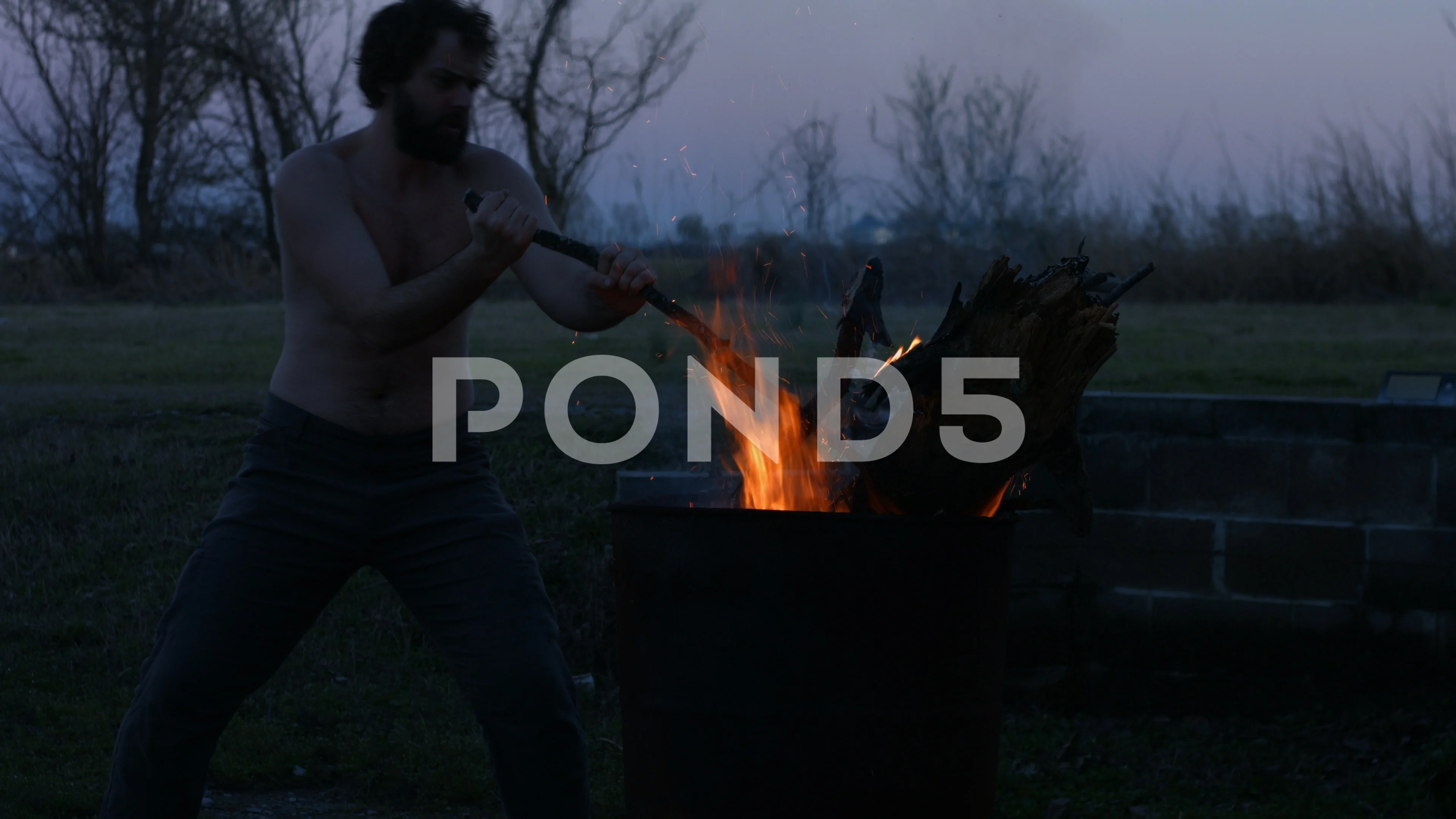 Person Tending Camp Fire