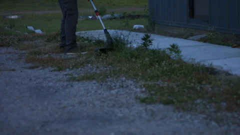 Young Person Weed Whacking Front Of Comm... | Stock Video | Pond5