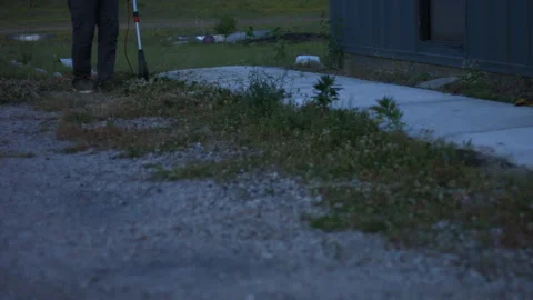 Young Person Weed Whacking Front Of Comm... | Stock Video | Pond5