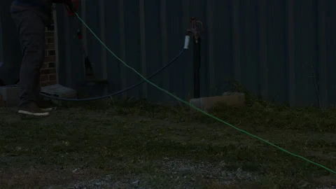 Young Person Weed Whacking Front Of Comm... | Stock Video | Pond5