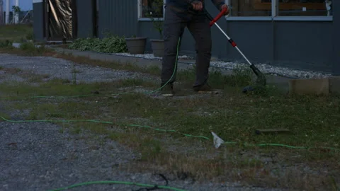 Young Person Weed Whacking Front Of Comm... | Stock Video | Pond5
