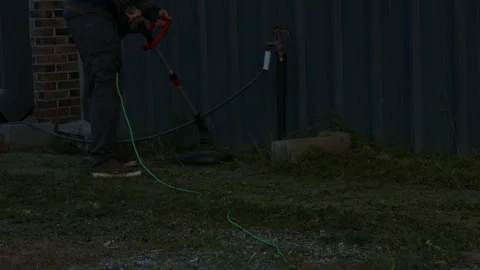 Young Person Weed Whacking Front Of Comm... | Stock Video | Pond5