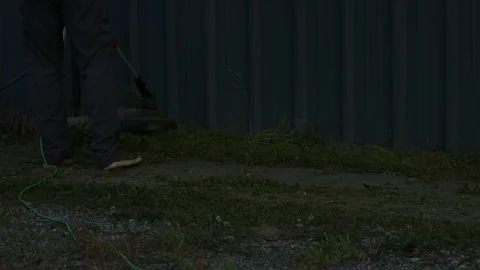 Young Person Weed Whacking Front Of Comm... | Stock Video | Pond5