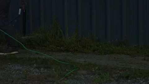 Young Person Weed Whacking Front Of Comm... | Stock Video | Pond5