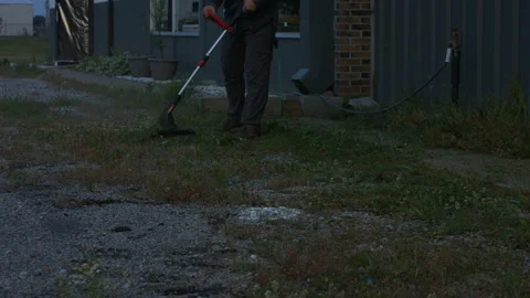 Young Person Weed Whacking Front Of Comm... | Stock Video | Pond5