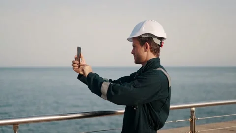 Young port worker wearing helmet and cov... | Stock Video | Pond5