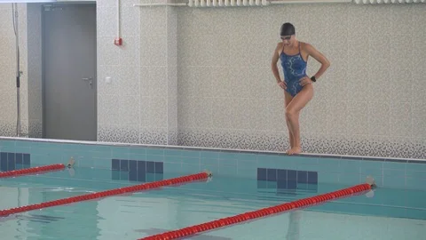 Young professional female swimmer jumpin... | Stock Video | Pond5