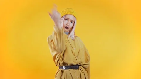 Young rude woman on yellow background sh... | Stock Video | Pond5