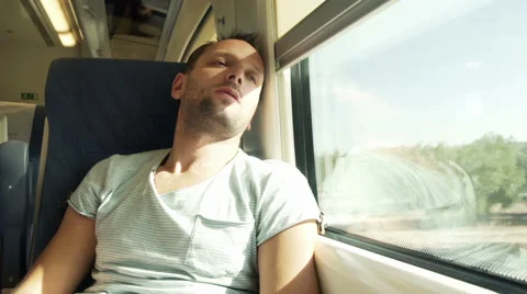 Young sad man sitting in the train and ... | Stock Video | Pond5